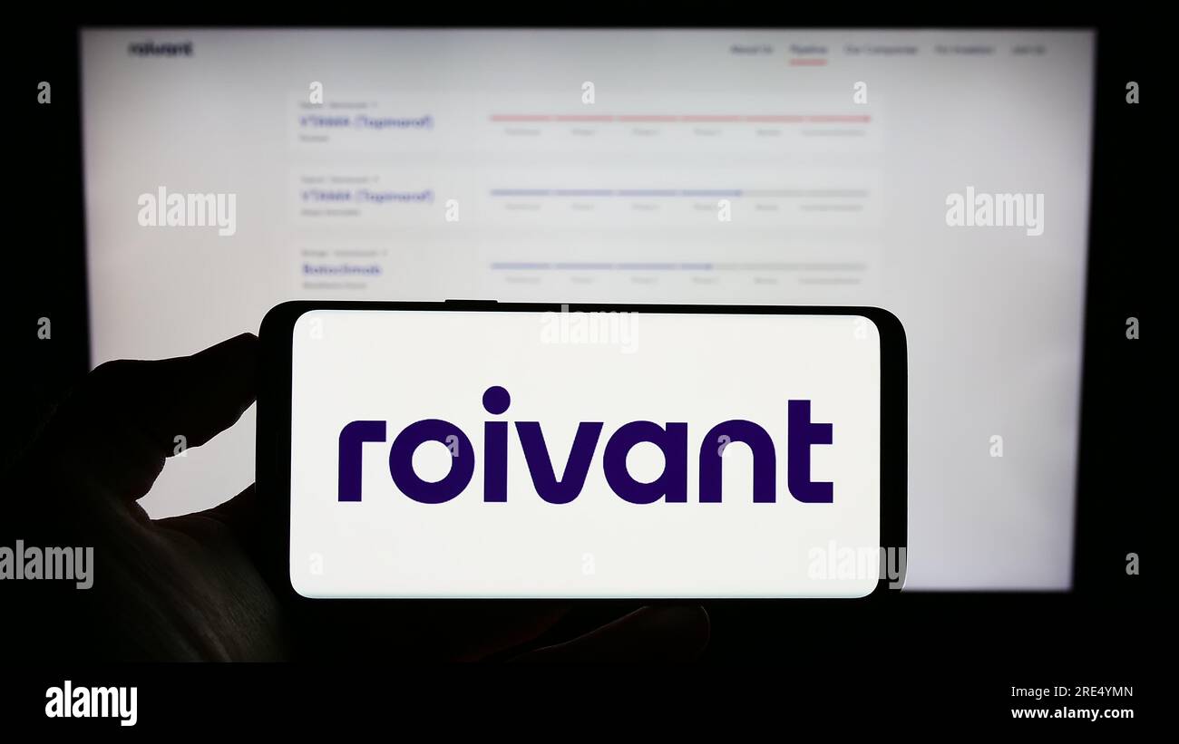 Person holding cellphone with logo of biotechnology company Roivant ...