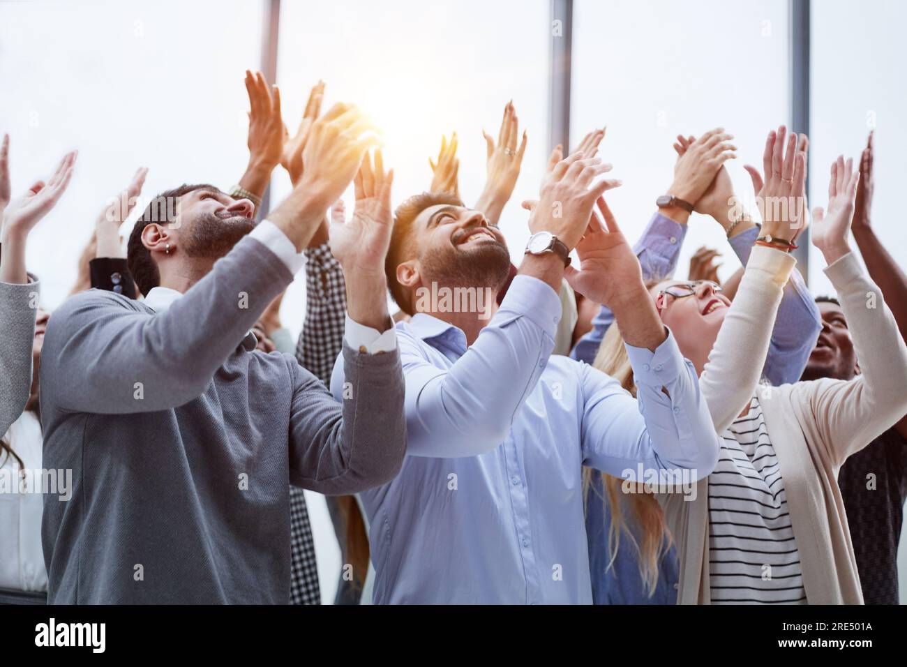 large group of diverse young people looking up hopefully Stock Photo ...