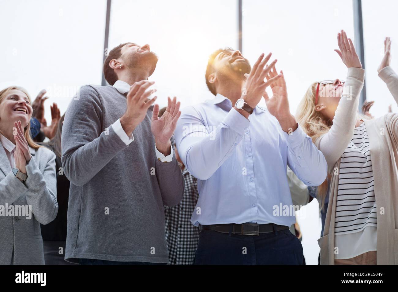 large group of diverse young people looking up hopefully Stock Photo ...
