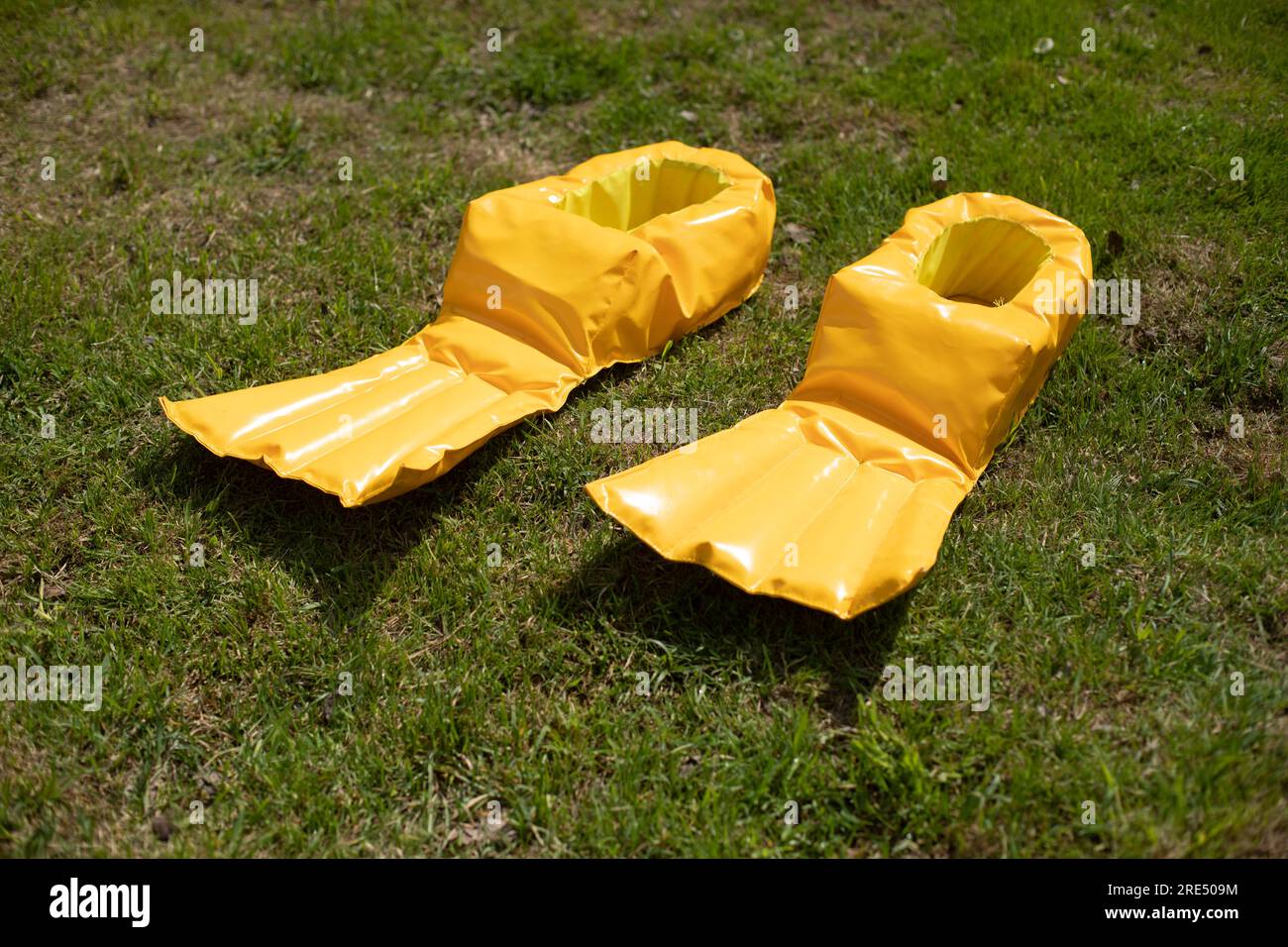Yellow boots to play with. Cheerful duck legs. Inflatable running boots ...