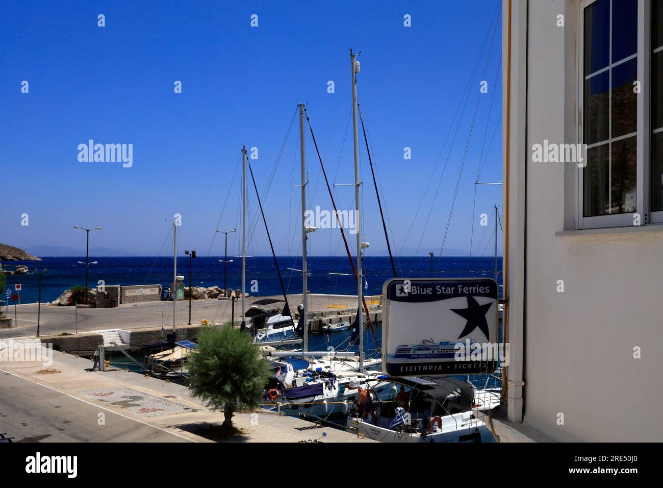 Blue Star Ferries sign at ferry ticket office, Livadia harbour, Tilos ...