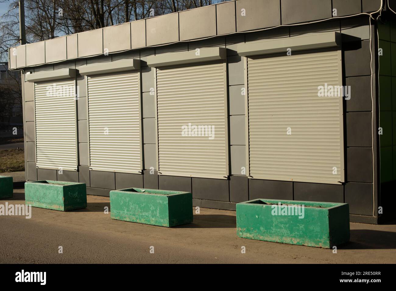 Office building with shutters on windows. Small Shop. Modern building ...