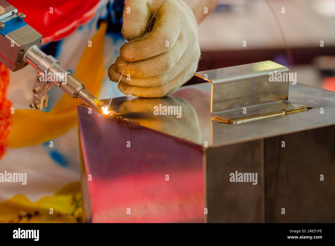 Close up: welder hands using handheld laser welding machine Stock Photo ...