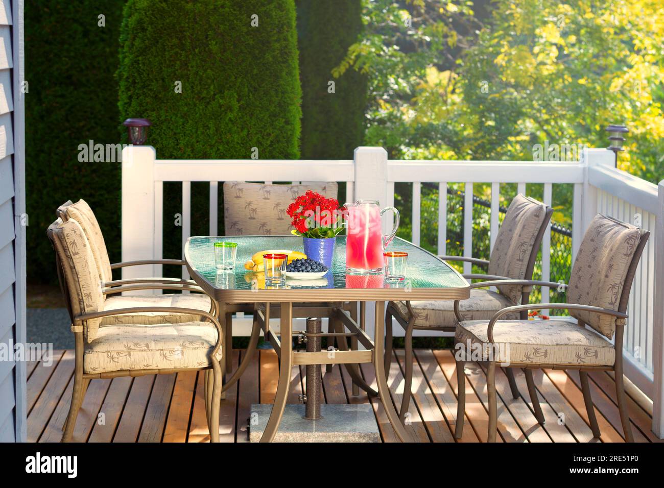 Healthy breakfast with juice and fruit on outdoor deck table during ...