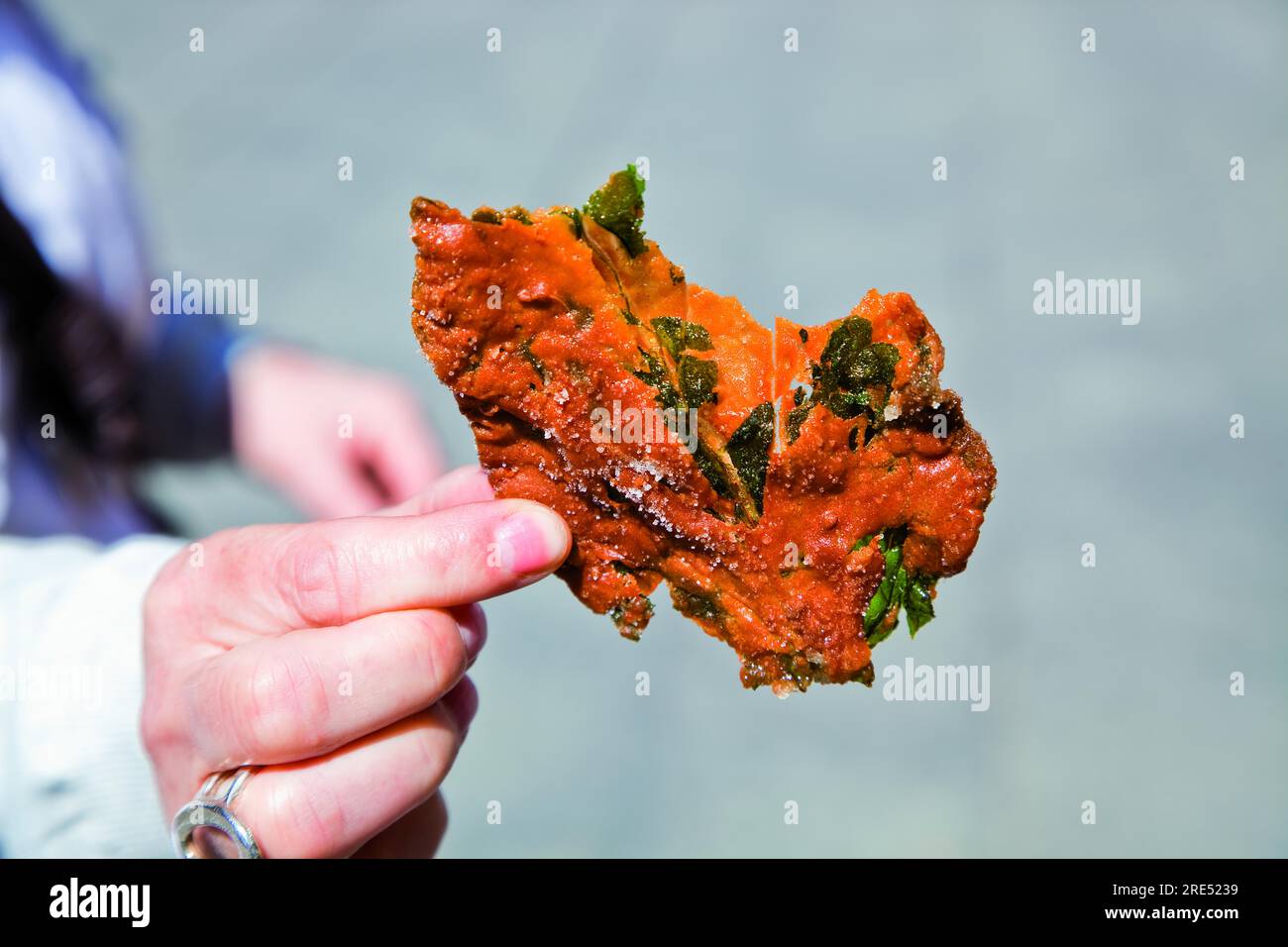 Hand holding a crespillo. Sweet pastries traditional Aragonese festival ...