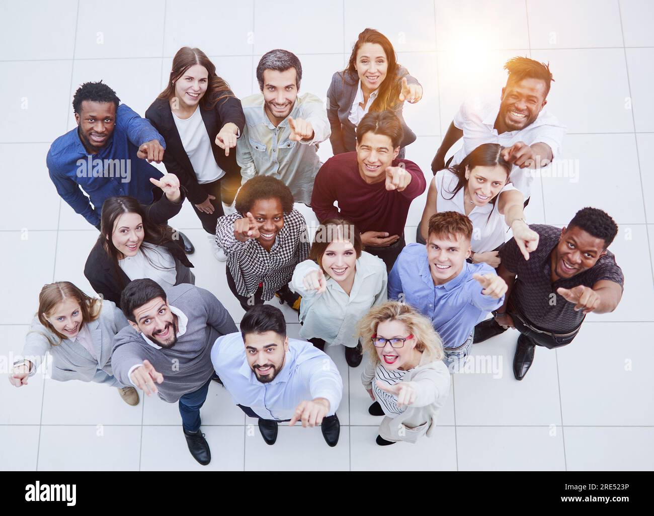 large team of young people pointing somewhere up Stock Photo - Alamy