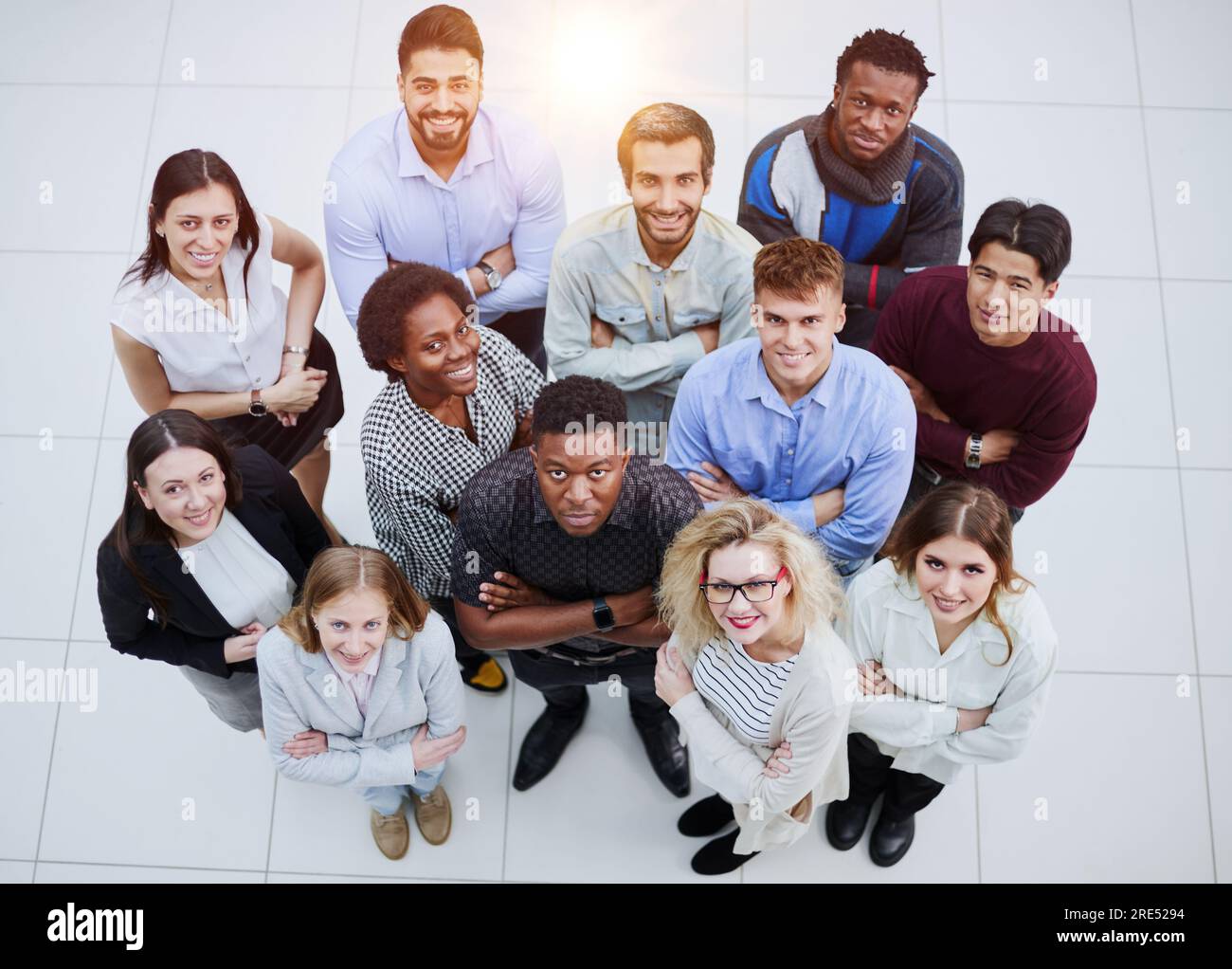 large group of diverse young people looking up hopefully Stock Photo ...