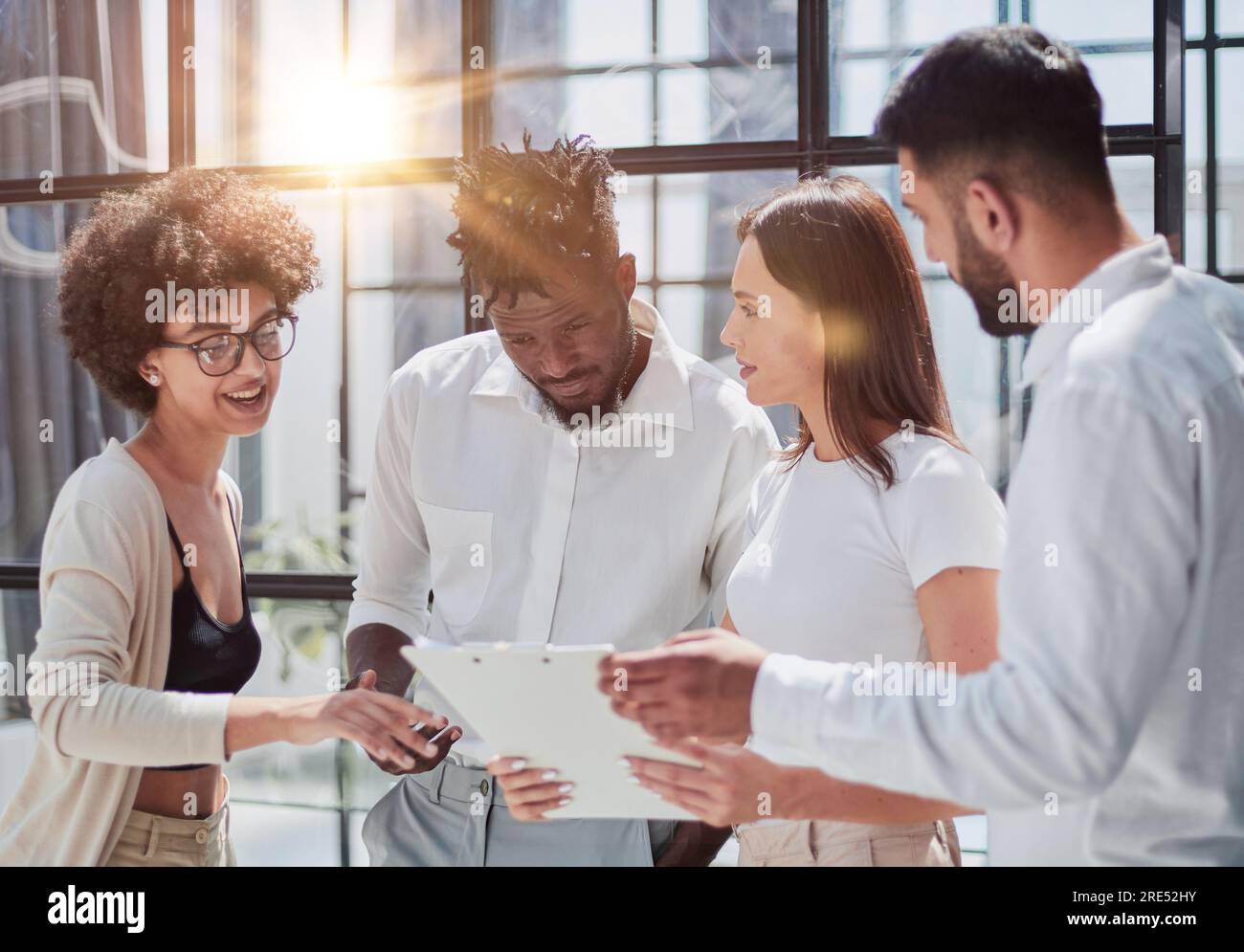 Employees working at computer together, discussing content Stock Photo ...