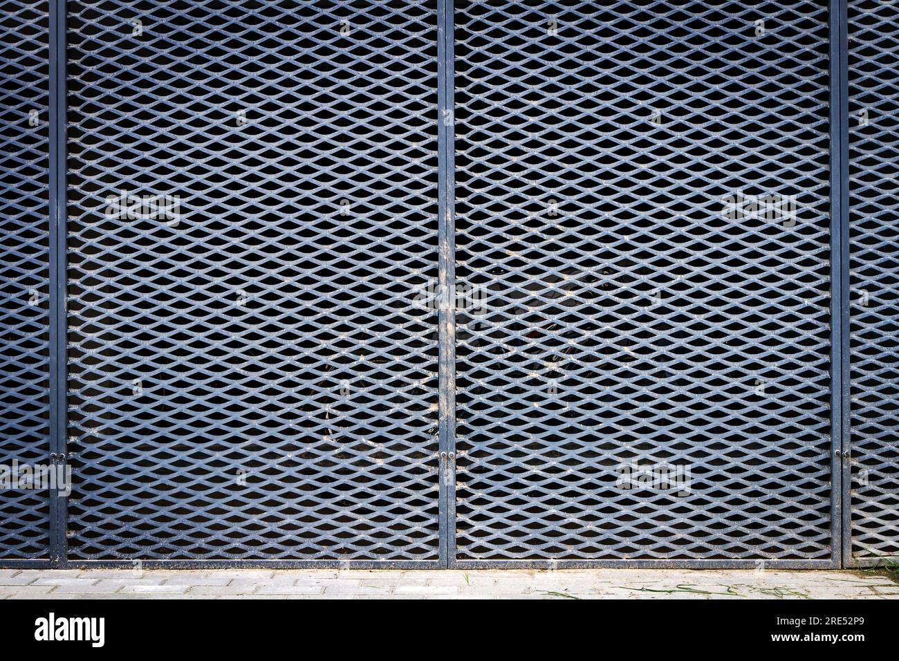 Iron grid wall and a sidewalk. Architecture detail background Stock ...