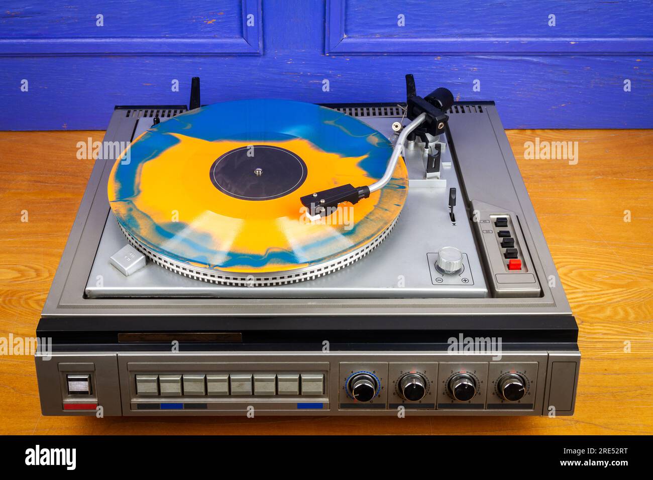 Vintage turntable vinyl record player with blue and orange vinyl on a ...