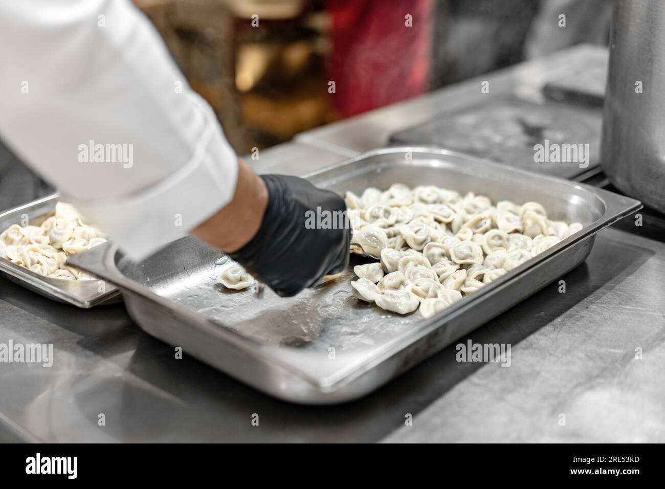 Chef cooking food at restaurant kitchen close up Stock Photo - Alamy