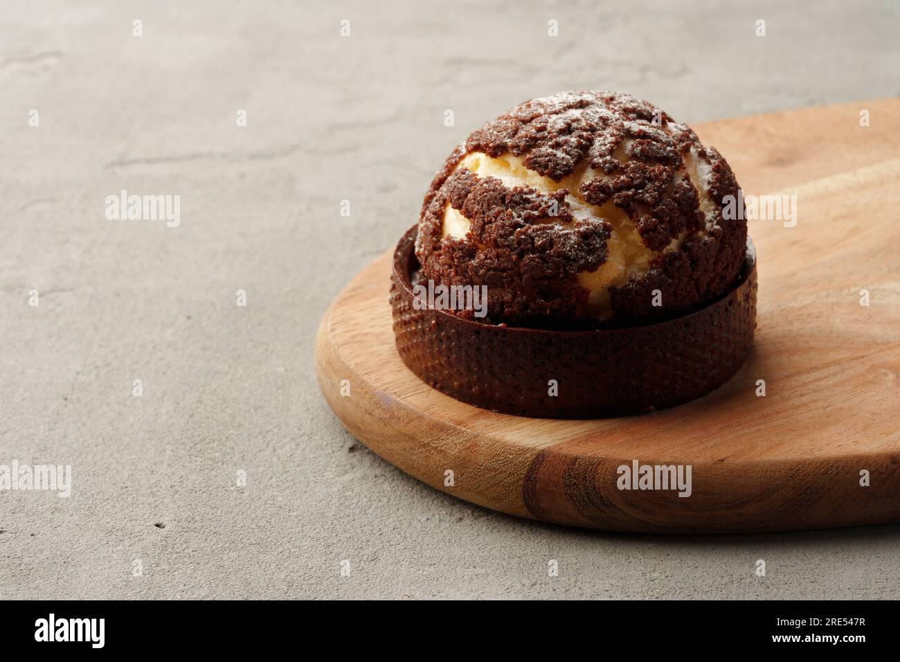Choux pastry with cracked chocolate crumble topping Stock Photo - Alamy