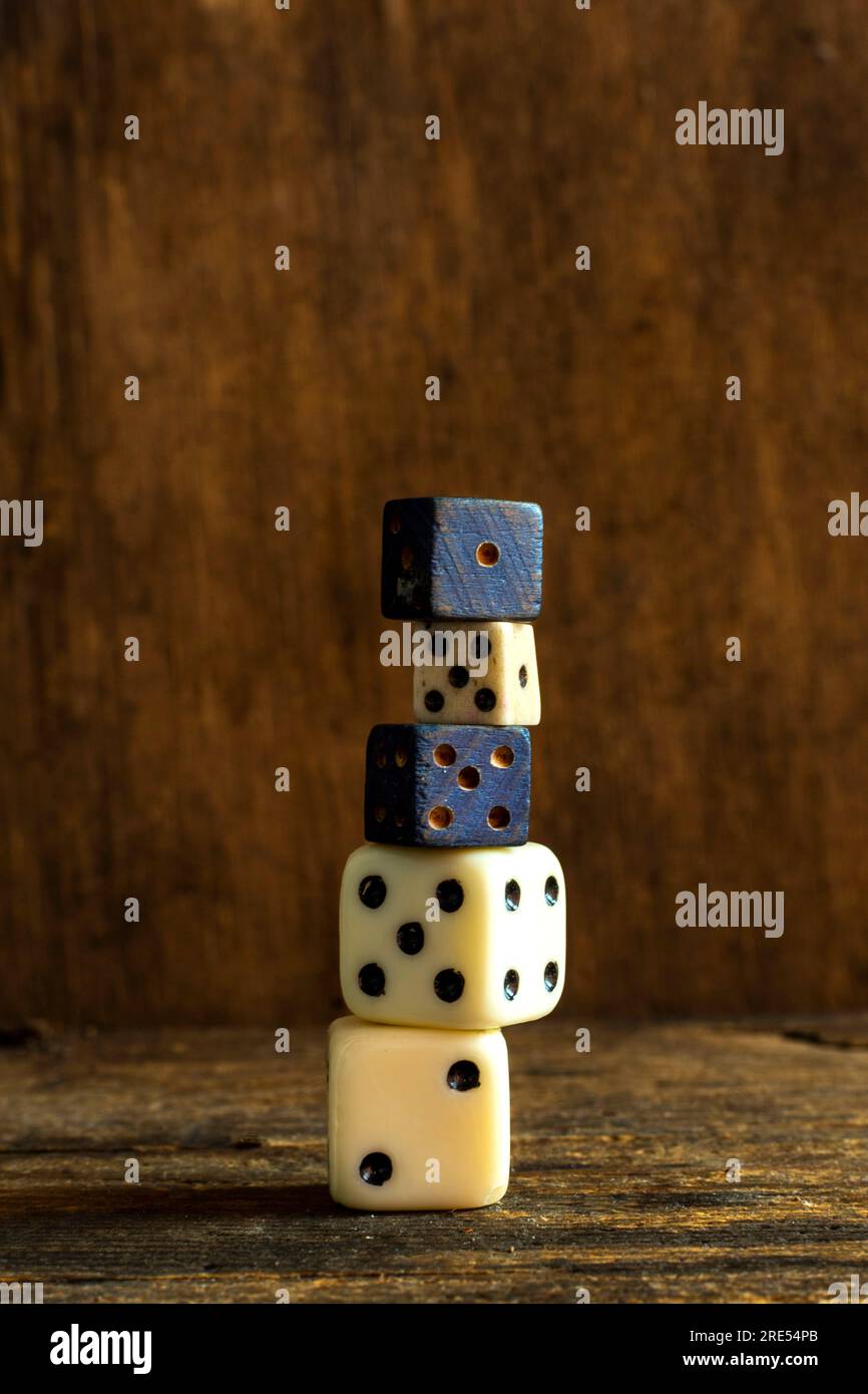 Stacked dice in a creative arrangement on a rustic wooden surface Stock ...