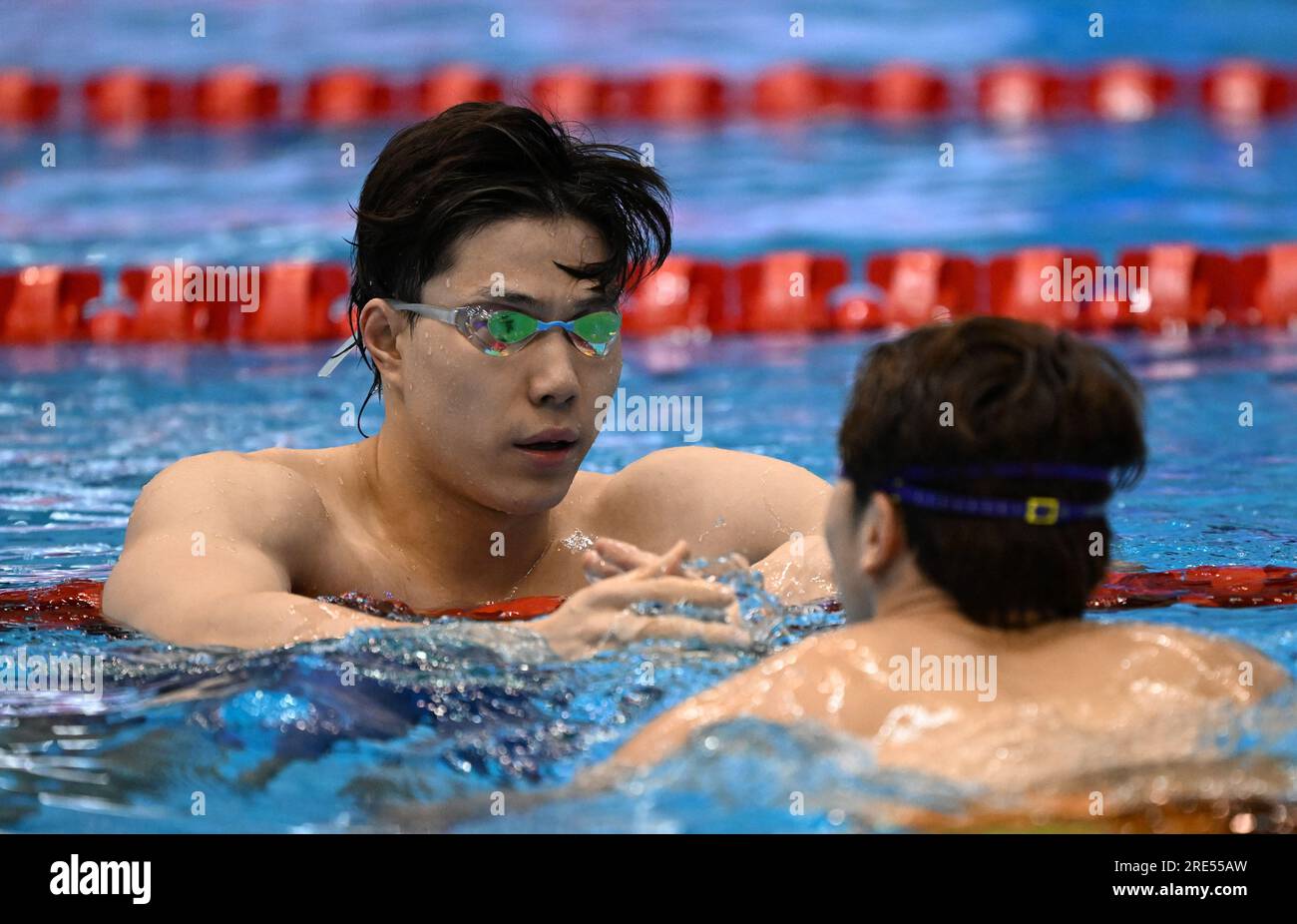 Fukuoka, Japan. 25th July, 2023. Qin Haiyang (L) of China celebrates ...