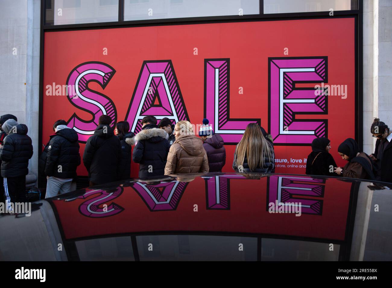 People wait outside Selfridges store on Oxford Street in London, ahead ...