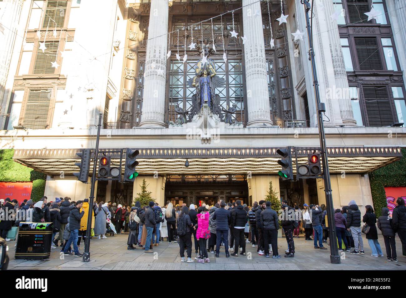People wait outside Selfridges store on Oxford Street in London, ahead ...