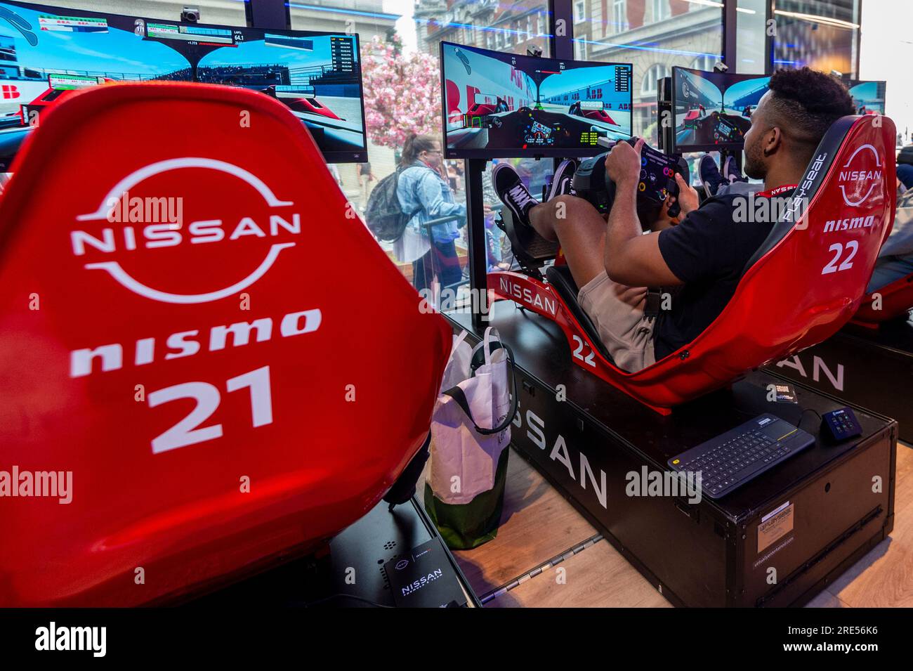 London, UK. 25 July 2023. Visitors experience racing simulators at the ...