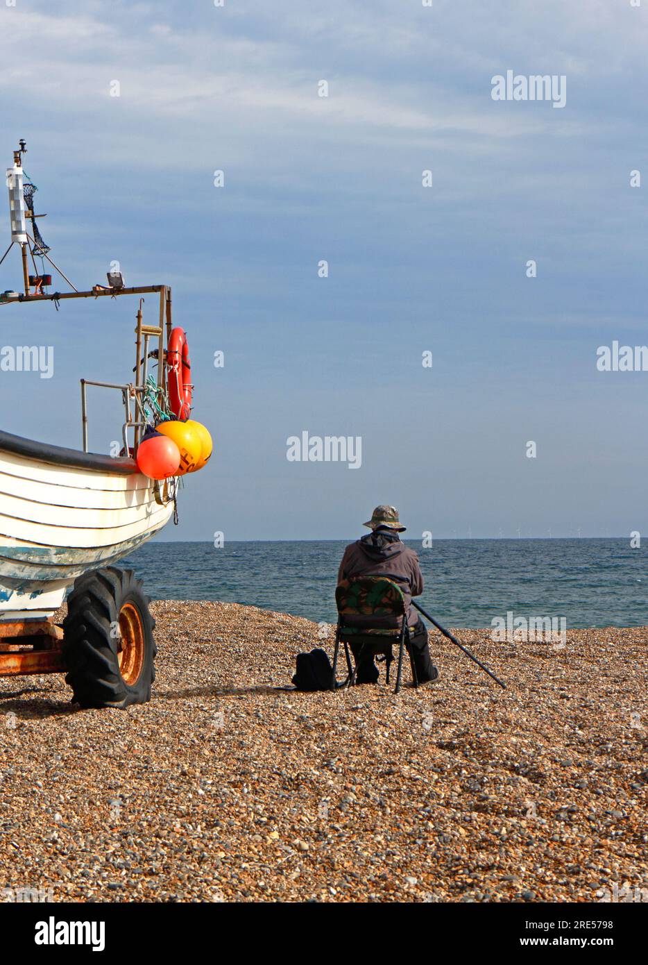 A birdwatcher sitting downwind of an inshore fishing boat watching for ...