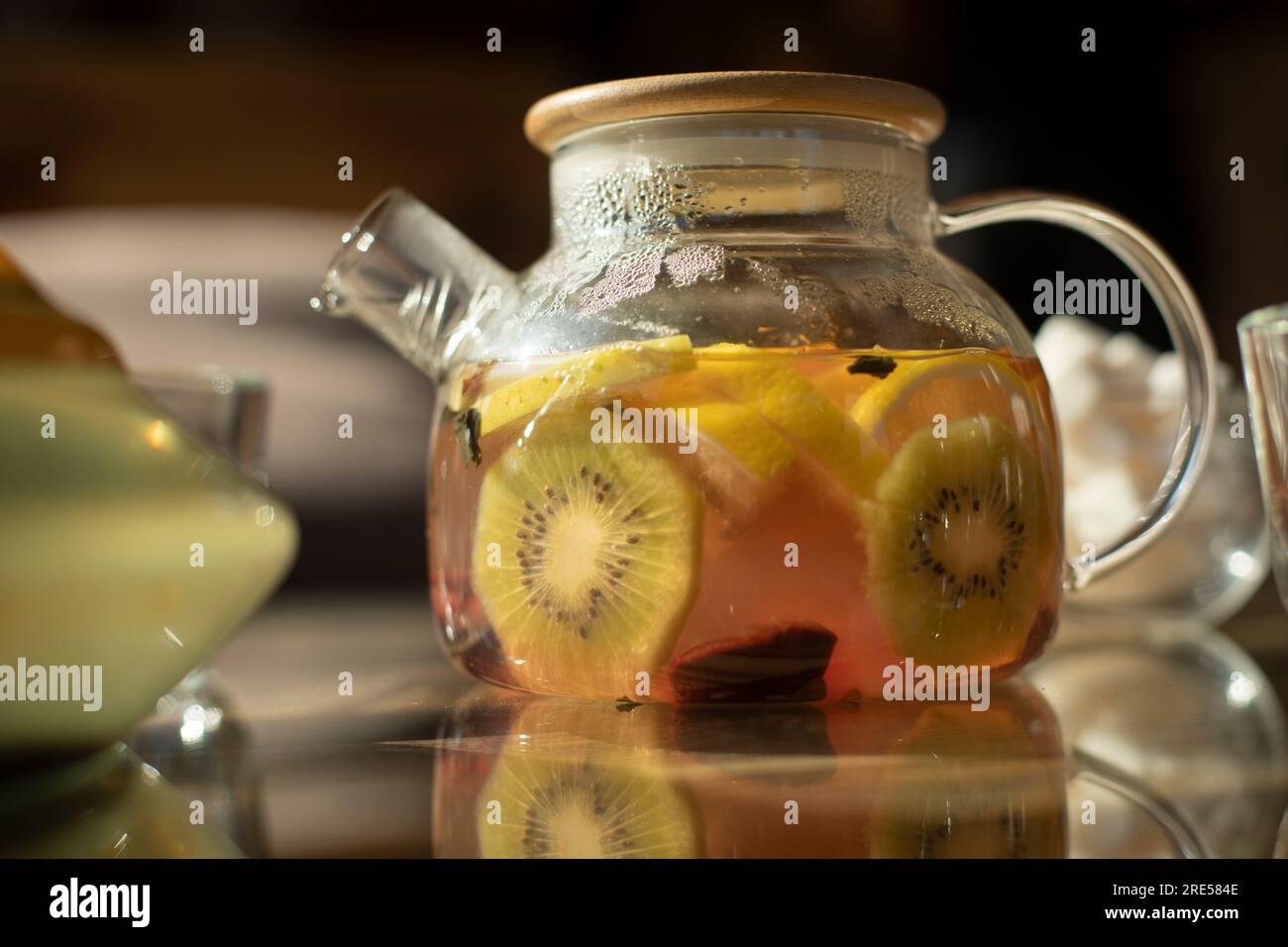 Fruit tea in teapot. Kettle on table. Fruits in summer. Healthy drink ...
