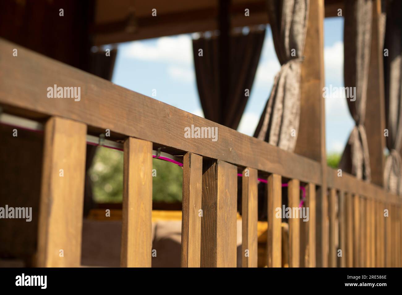 Veranda made of wood. Fence from boards. Street restaurant. Brown fence ...