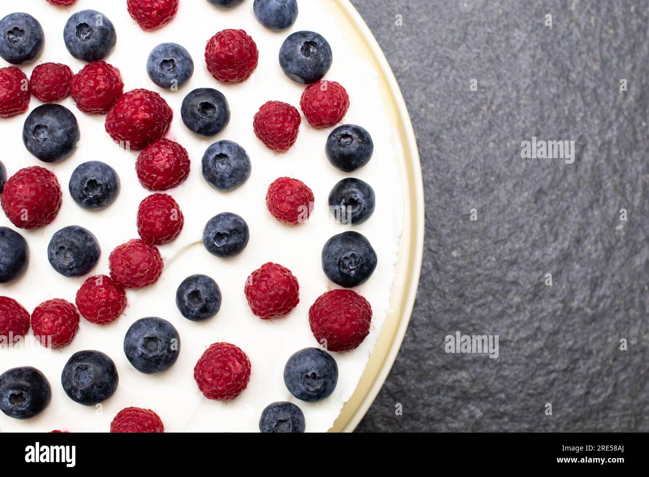 Cheese cake strawberry and raspberry on creamy white flat layer ...