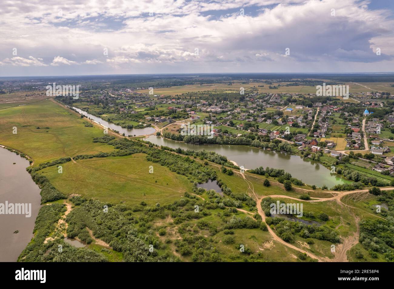 Aerial drone top view over Liukhcha village, Sluch river and lake in ...