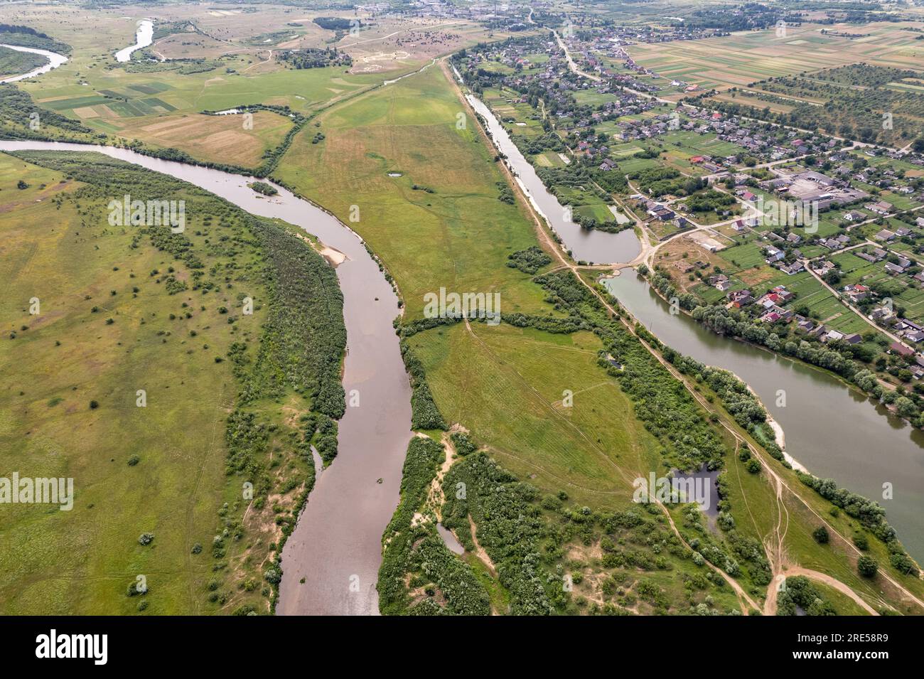Aerial drone top view over Liukhcha village, Sluch river and lake in ...