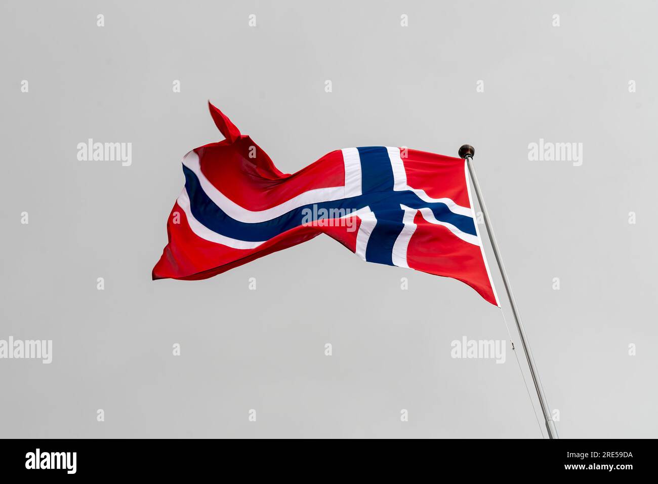 Norway flag flying against plain cloud background Stock Photo - Alamy