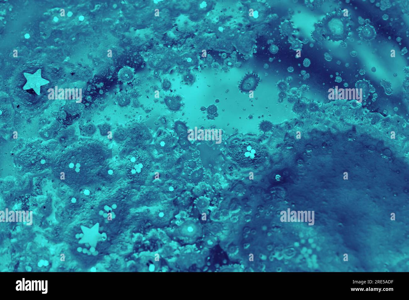abstract background with golden glitter and liquid crystal effect. Blu ...