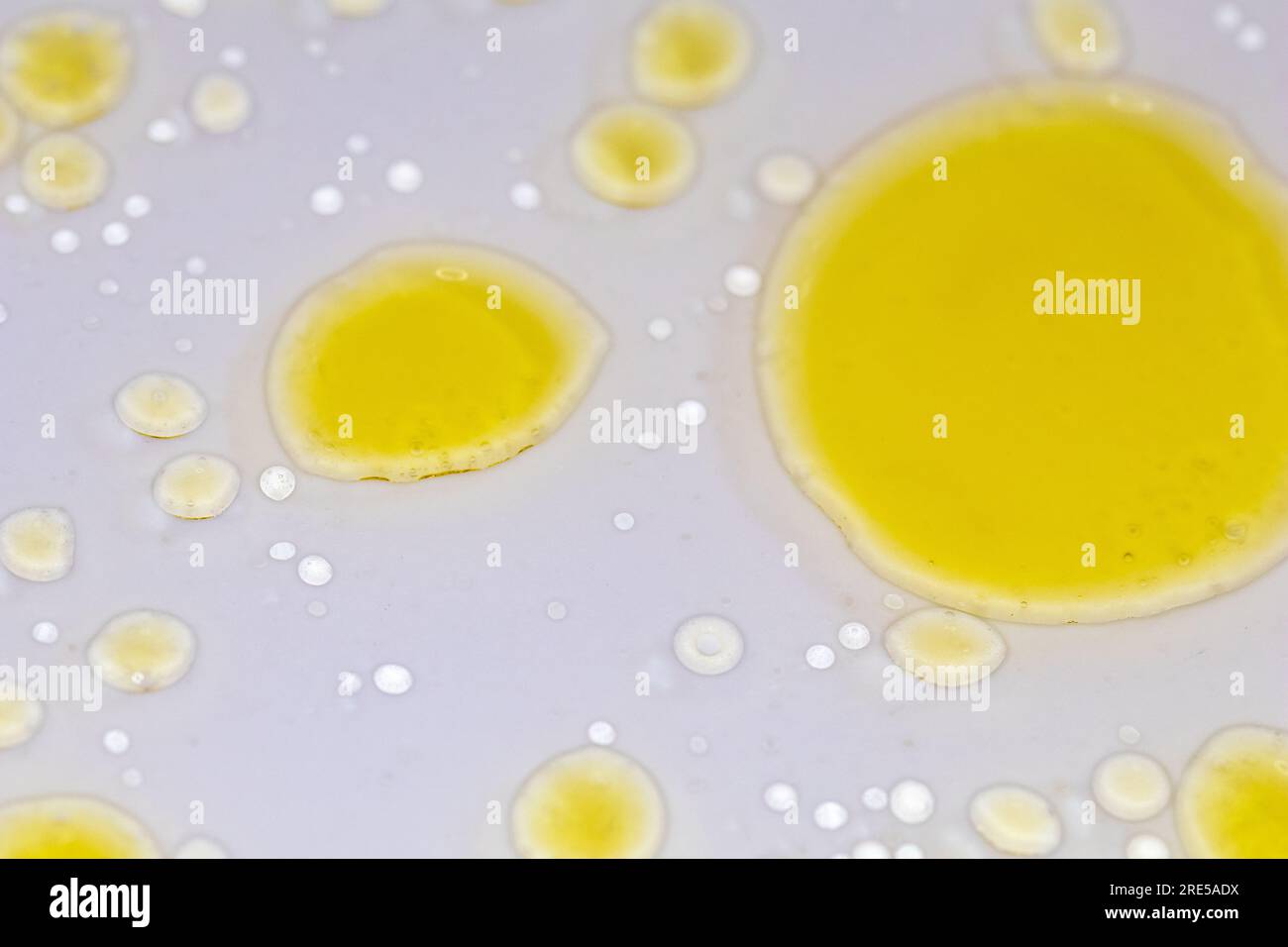 yellow liquid bubbles on white background, abstract chemical scientific ...