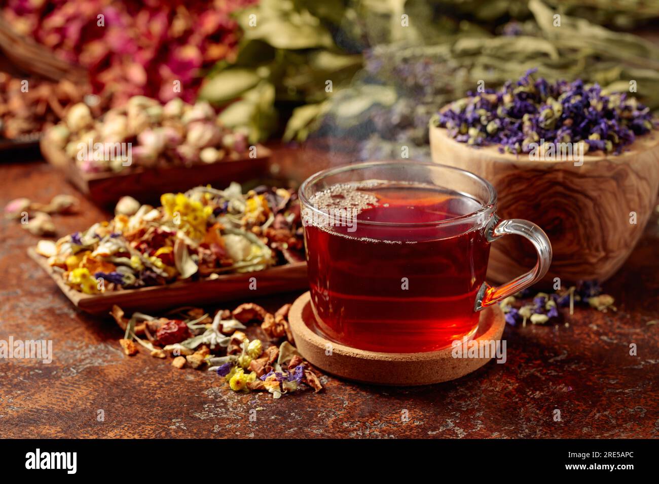 Herbal tea and a mix of various dried medicinal plants and herbs on a ...