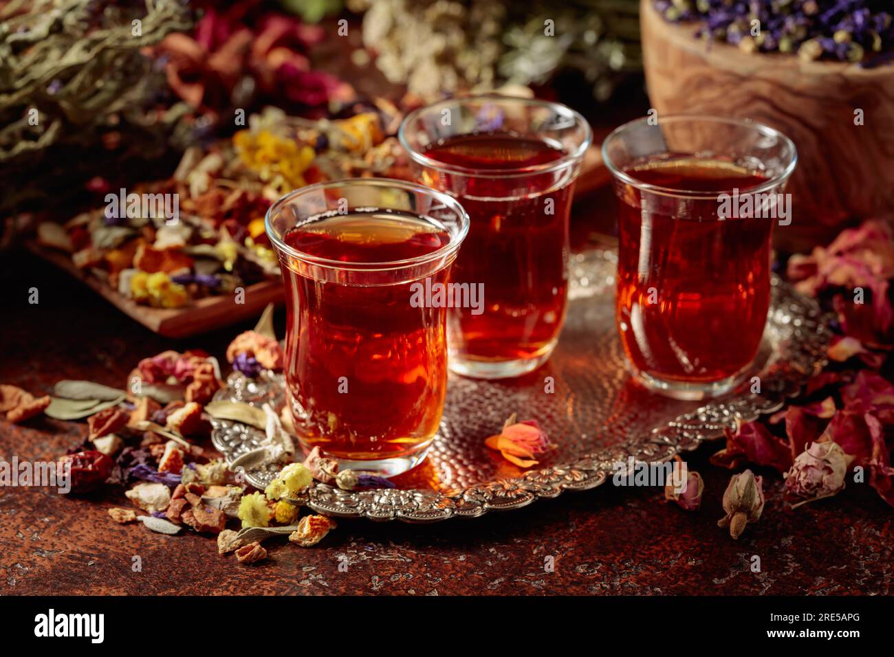 Herbal tea and a mix of various dried medicinal plants and herbs on a ...