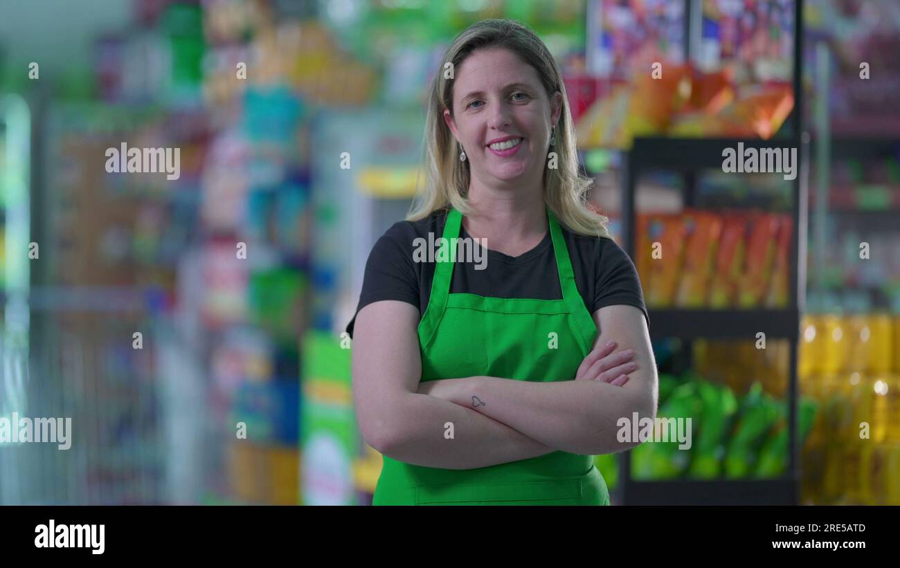 Happy Woman Employee of Grocery Store with Arms Crossed smiling Inside ...