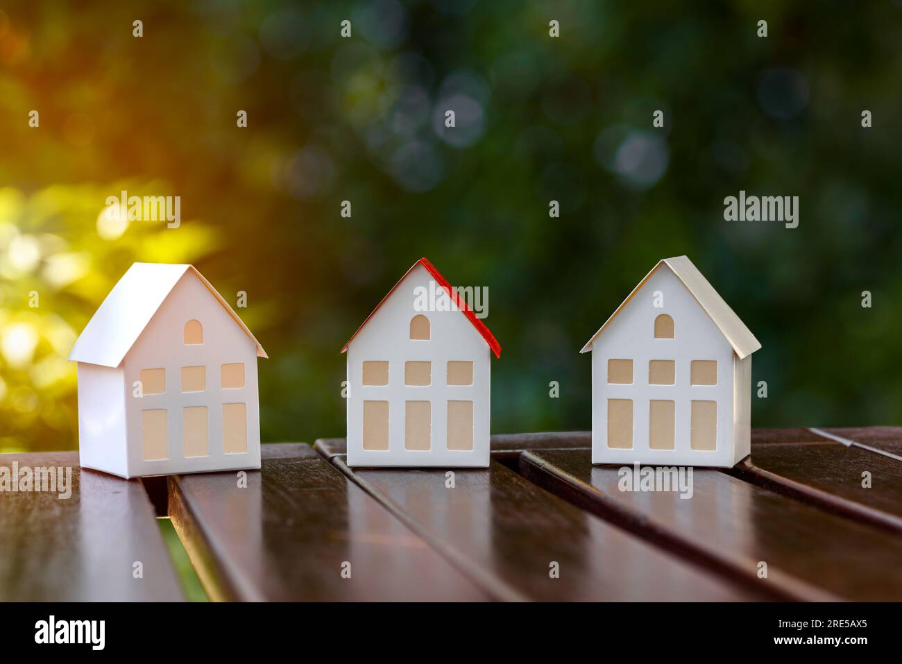 White paper house models on a table outdoor with blurred background ...