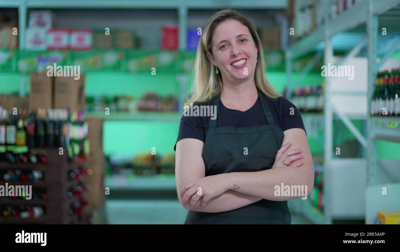 Joyful Expression of Female Supermarket Employee with Arms Crossed at ...