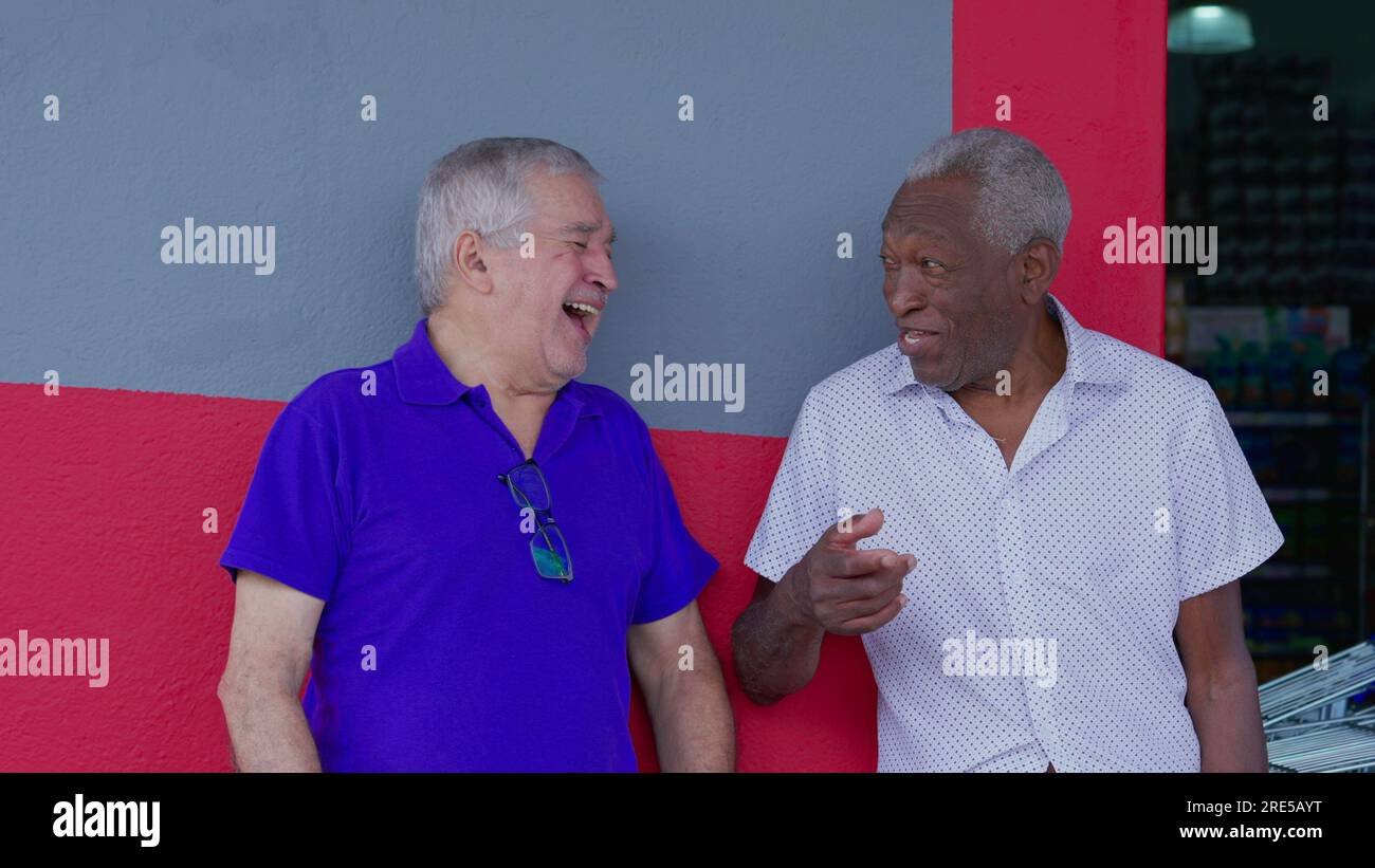 Joyful two diverse male senior friends smiling and laughing together ...