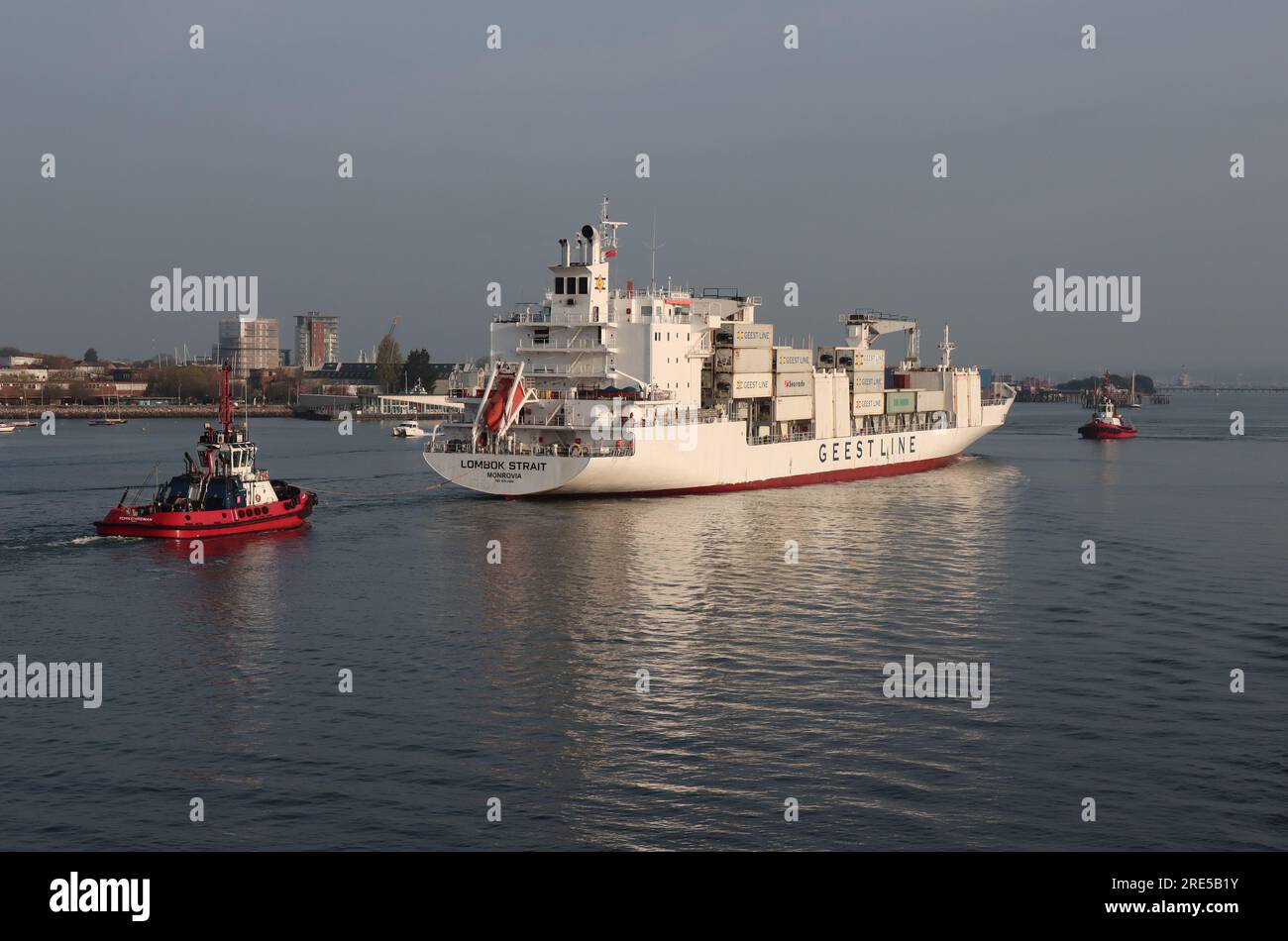 Tugs assist the refrigerated cargo ship MV LOMBOK STRAIT as it heads ...