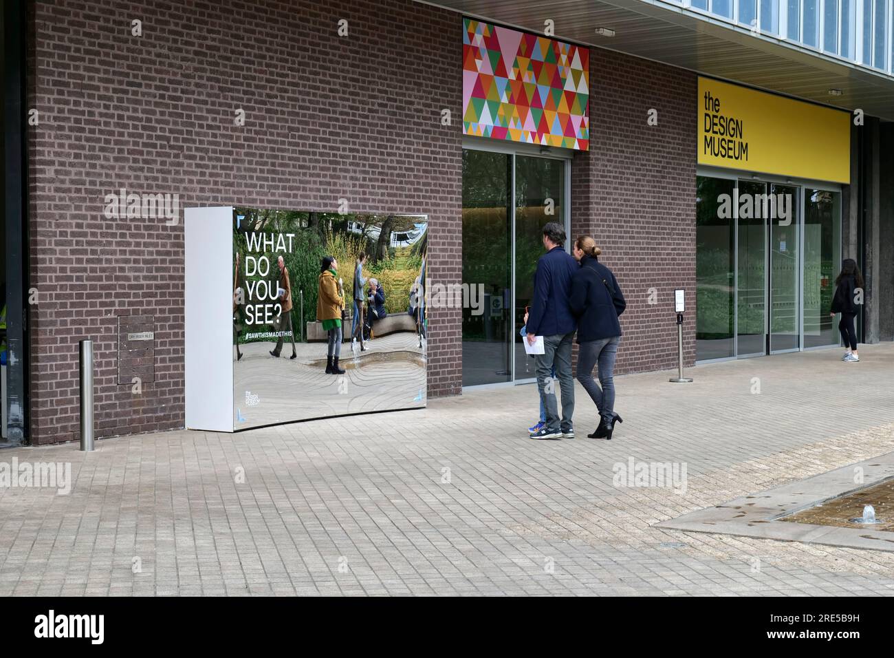 people look at distorting mirror outside the Design Museum London ...