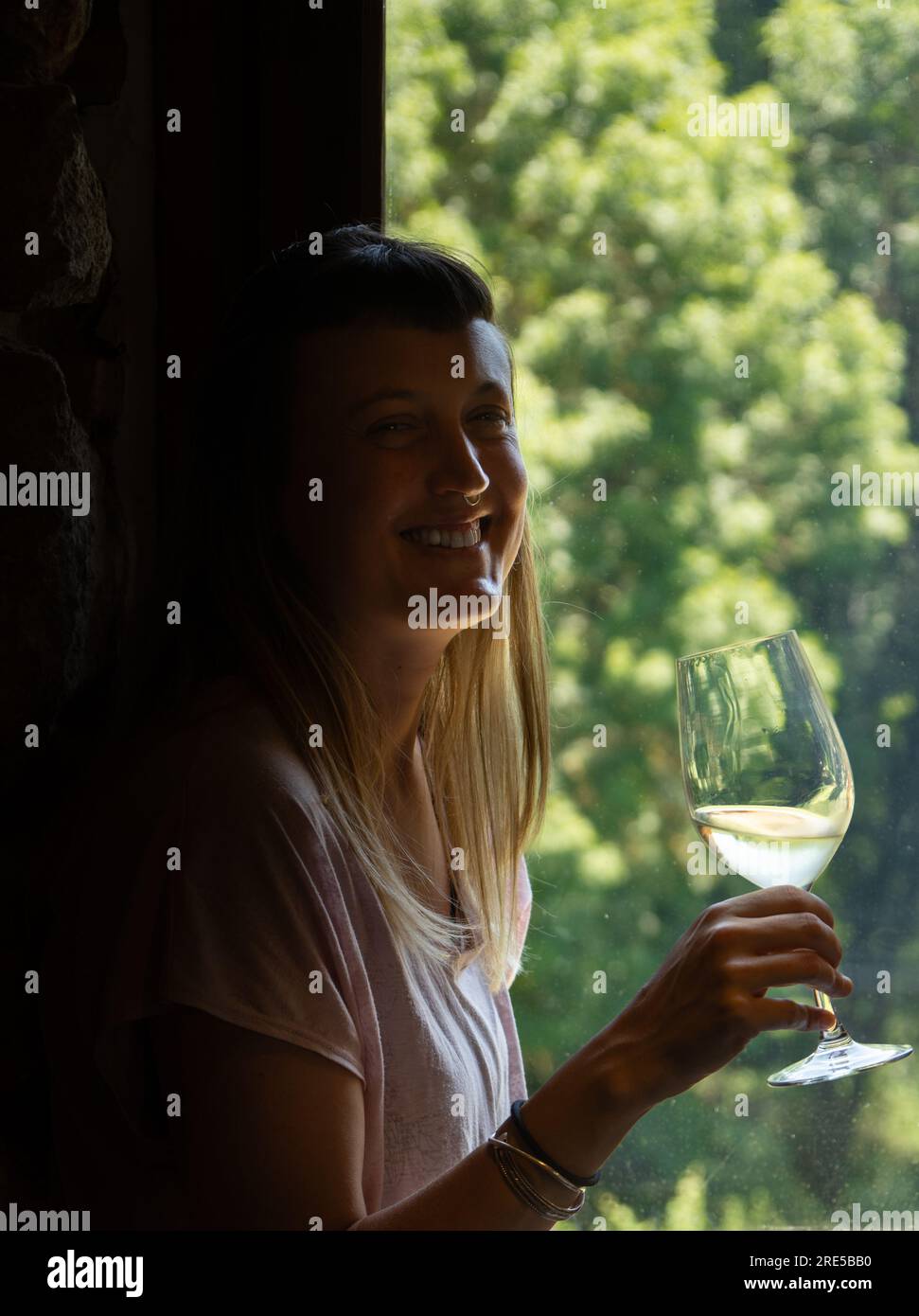 Young, pretty, alternative woman with long hair and a nose piercing ...