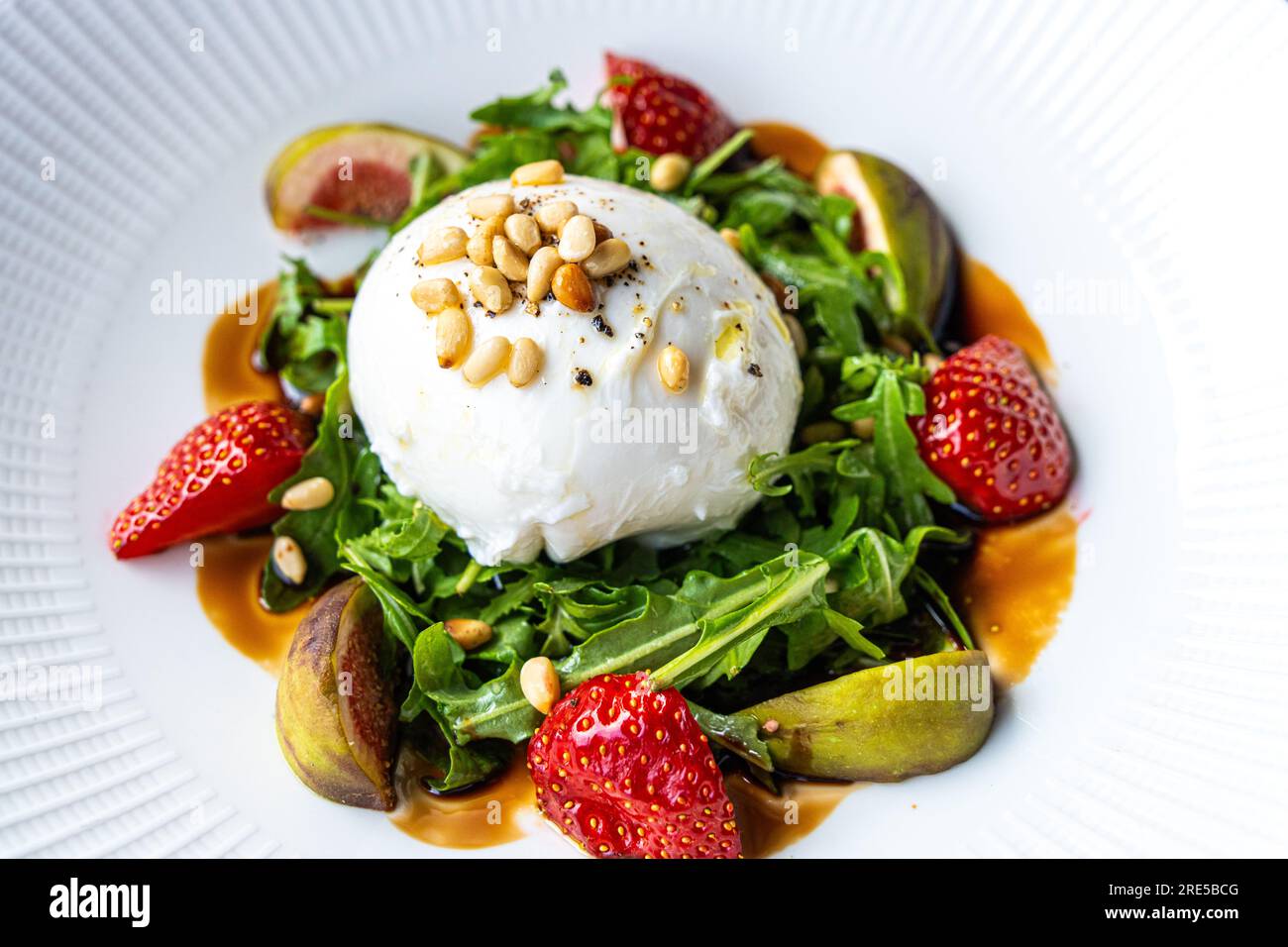 Burrata cheese italian salad strawberries, rucola, fig, pine nuts ...