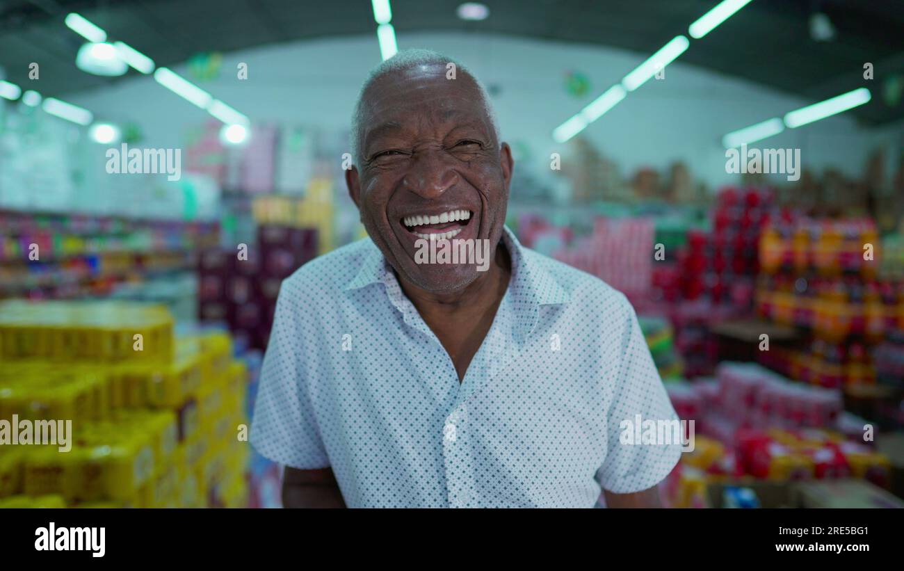 One happy black Brazilian senior man smiling and laughing standing ...