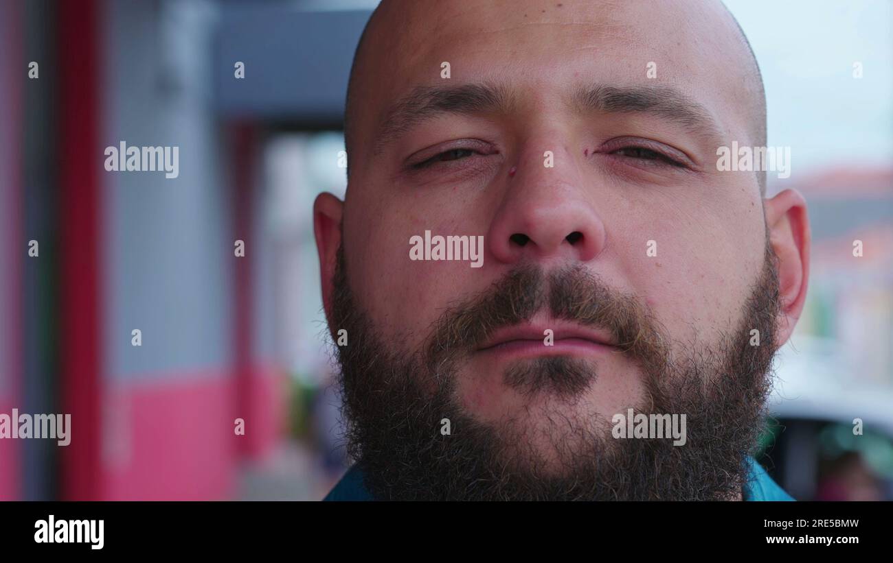 Portrait of a stern serious casual bold man with beard tight close-up ...