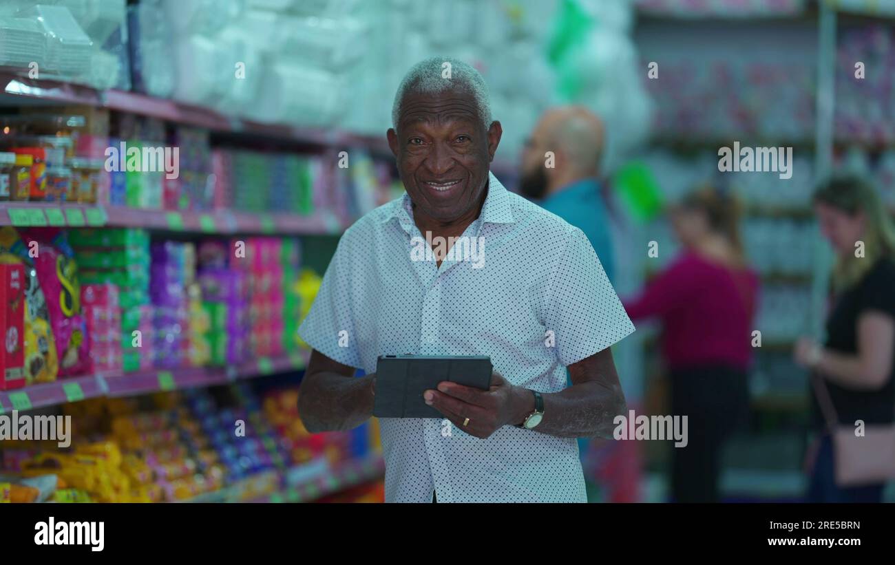 One Black Senior Manager Checking Grocery Store Inventory with Tablet ...