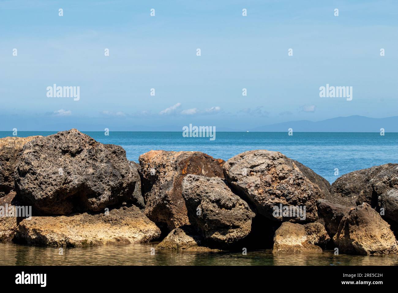 Sea and rock background. Rock and blue sea with clear sky. Seaside ...