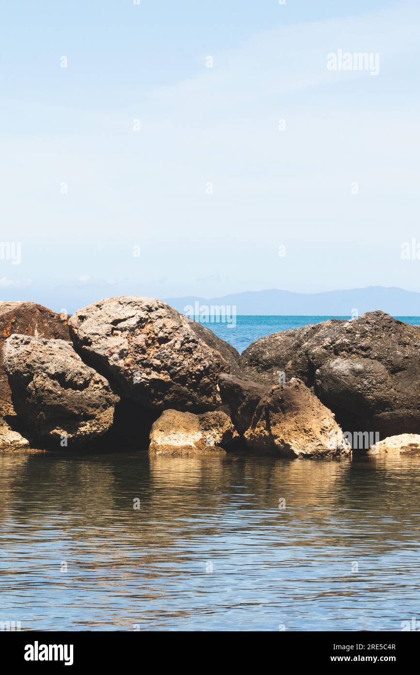 Sea and rock background. Rock and blue sea with clear sky. Seaside ...