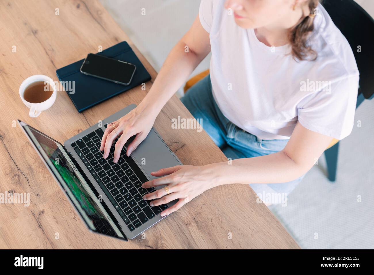 Woman working, learns, using laptop computer on table. Writing, typing ...
