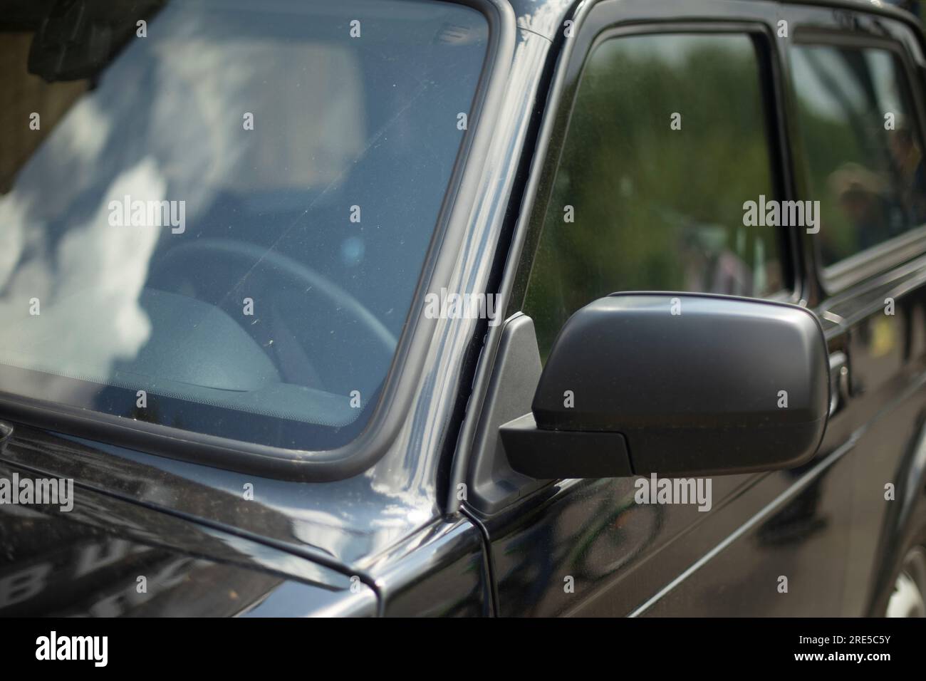 Black car in detail. Front rearview mirror. Car windshield. Machine ...