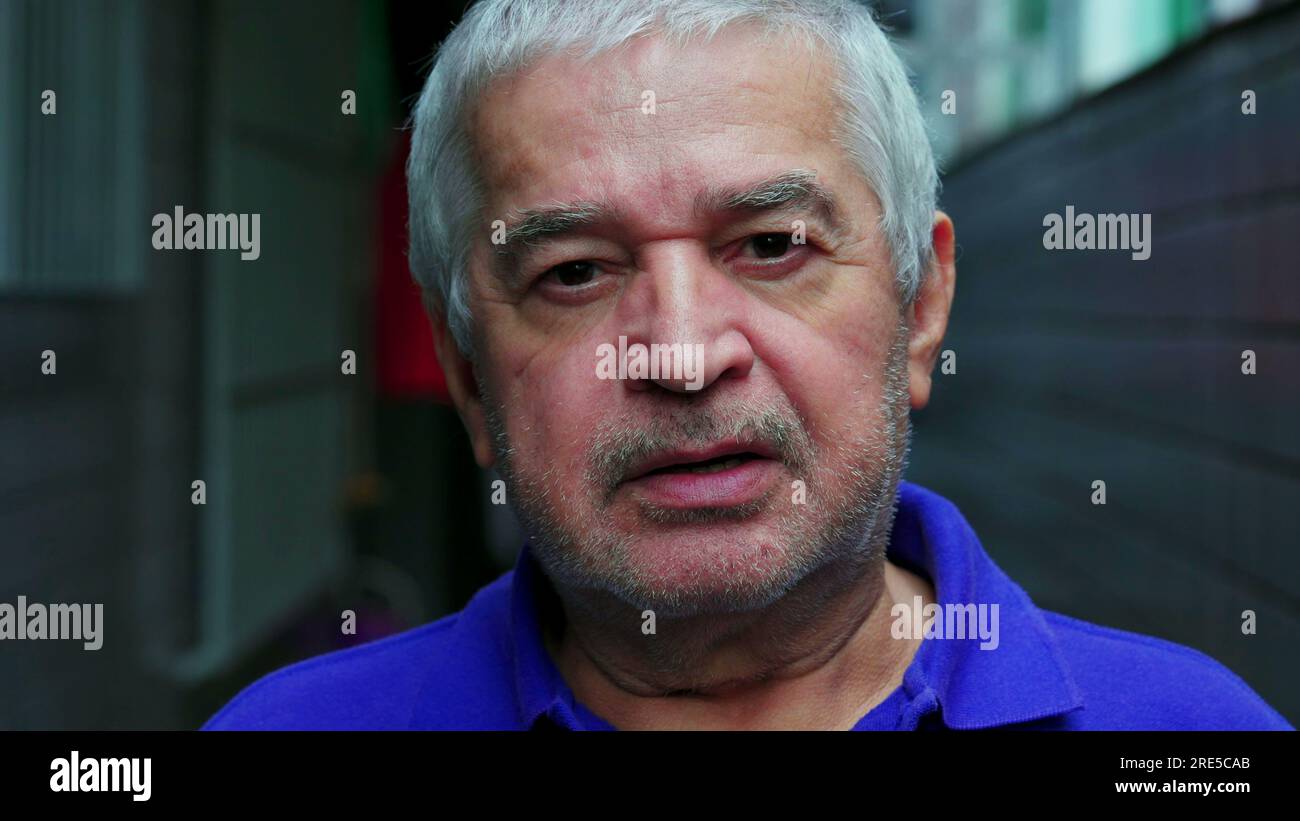 Senior man close-up face changing emotion from happy to serious ...