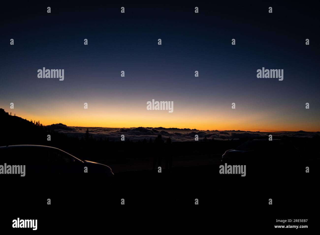 Sunset, almost dark with horizon low light from an high mountain. Sea ...