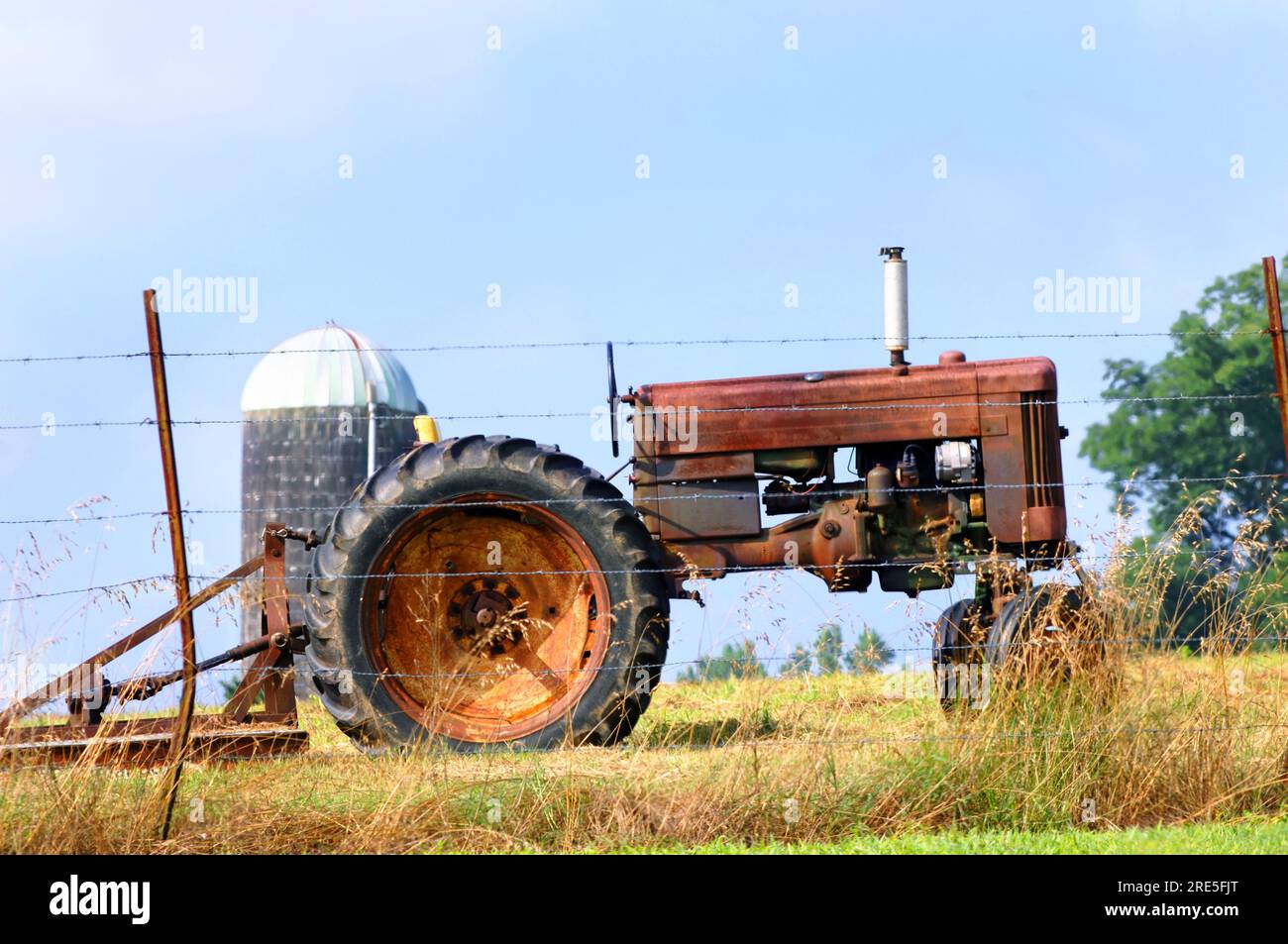 A relic of farming is parked at the fence row to be sold. Tractor and ...
